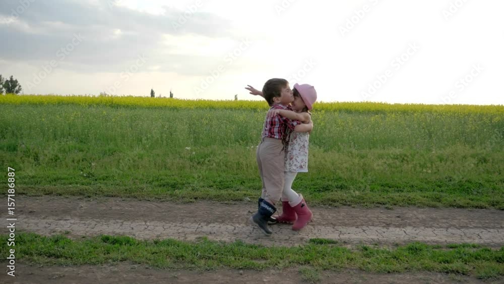 children friends hugging each other, running around field road, slow ...