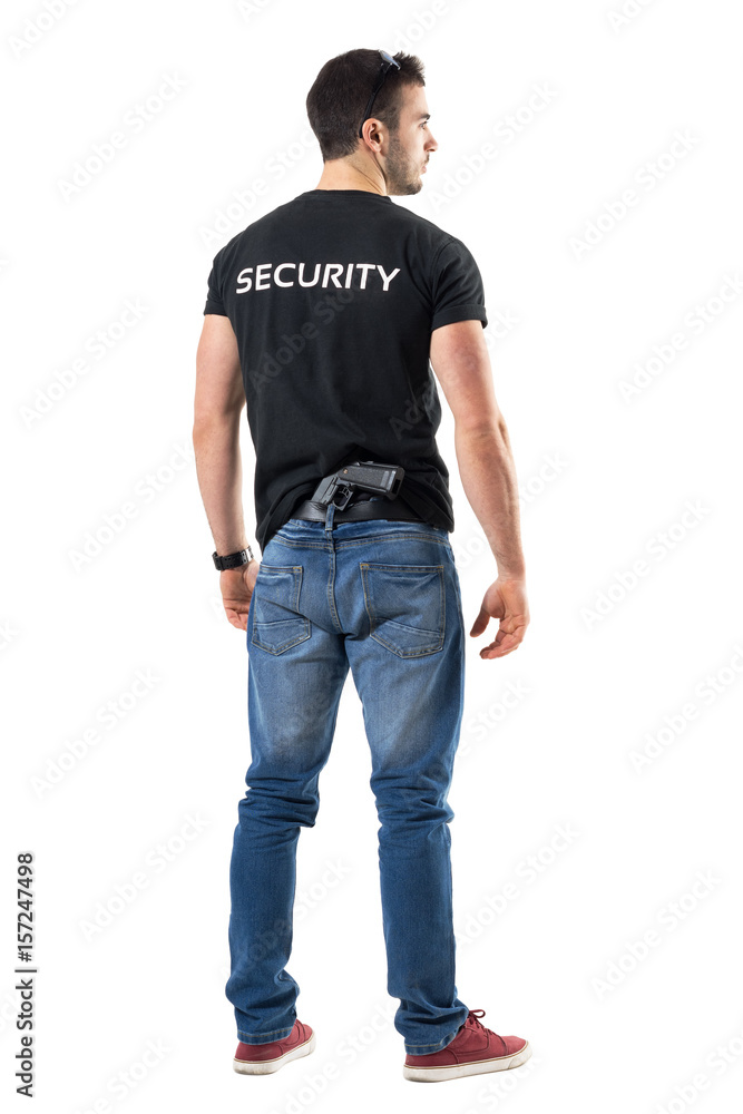 Rear view of undercover policeman with gun attached on his back belt ...