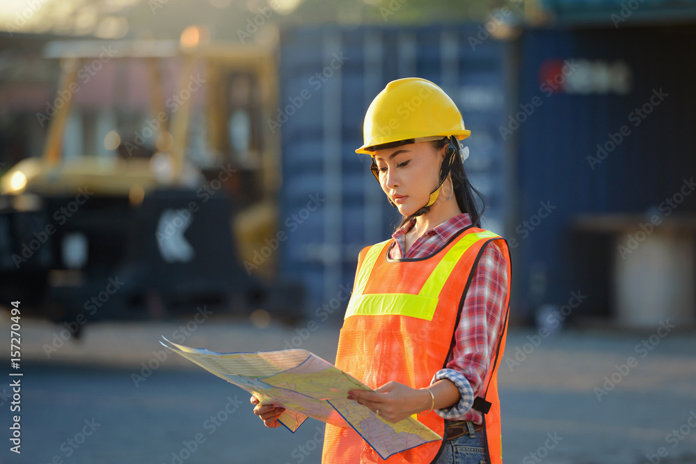 Woman engineering on transportation site map on during sunset,Woman ...