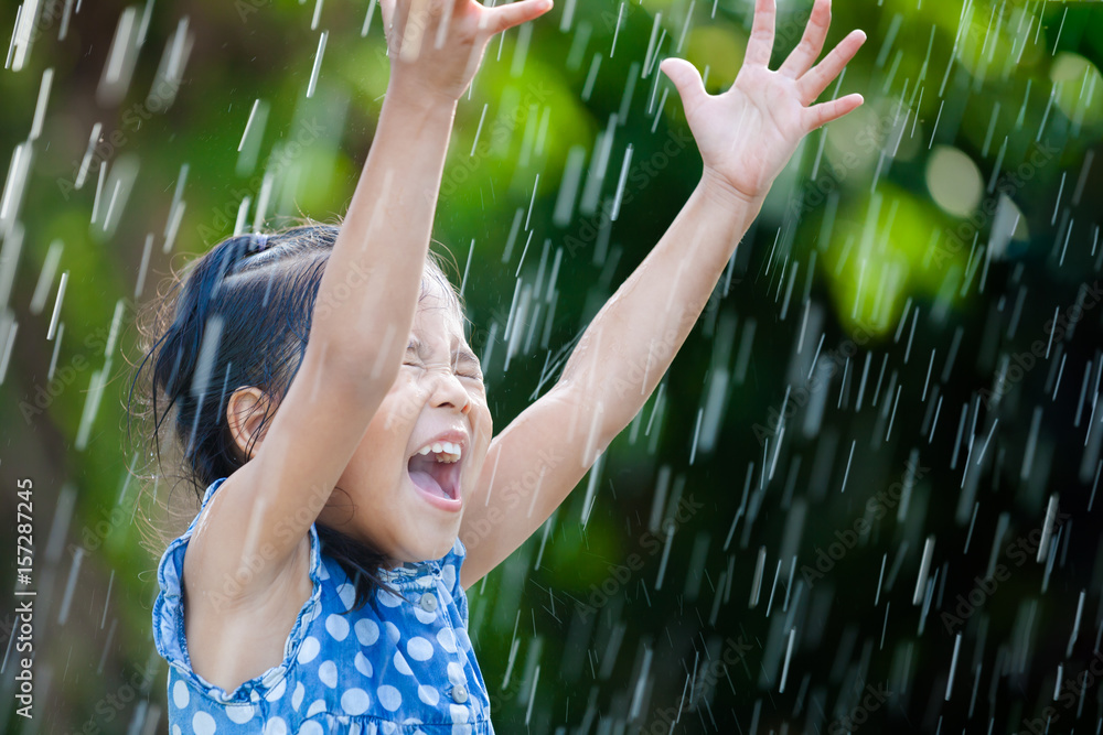 Happy asian little girl having fun to play with the rain Stock Photo ...