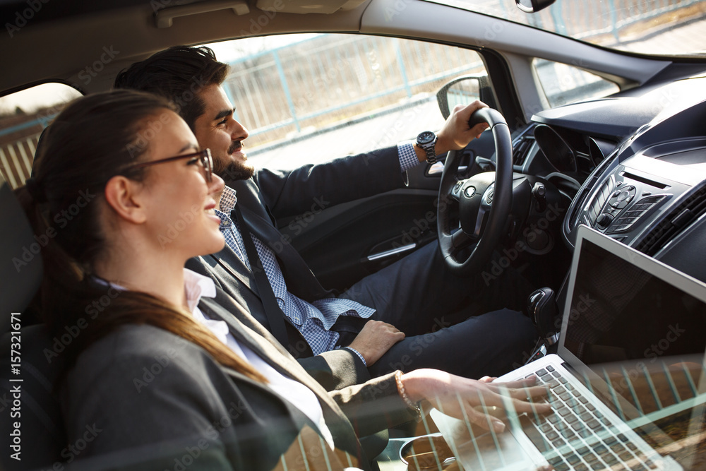 Two business people in the car.They travel to business meeting.Man ...