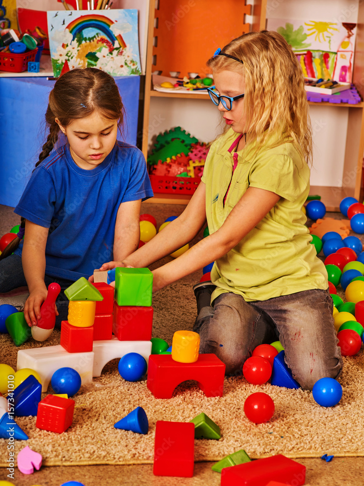Break school of children playing in kids cubes indoor. Two girl ...