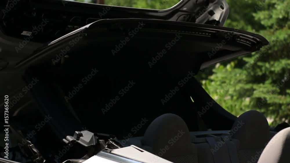 Automated Moon roof of convertible sedan being put up over a car Stock ...