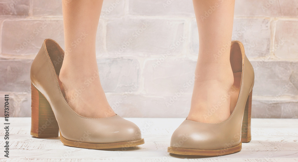 Little girl wearing mom's shoes Stock Photo | Adobe Stock
