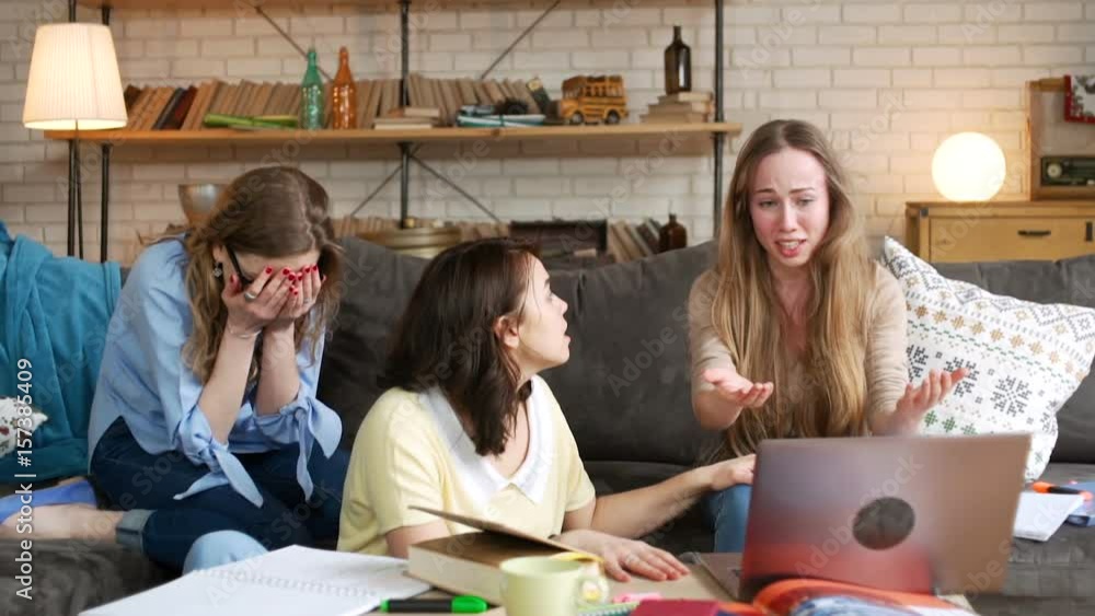 young female student becomes nervous and upset, because computer laptop ...