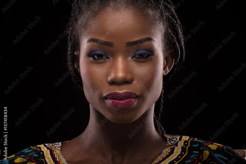 Dark skinned model posing on black background. Beautiful model with ...