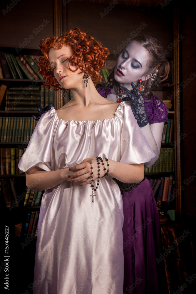 Vampire girl bites the victim's neck Stock Photo | Adobe Stock