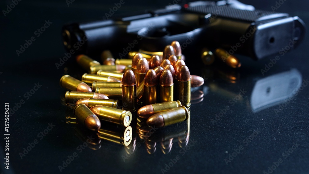 Bullets on the black mirror floor. Bullets are a projectile expelled ...