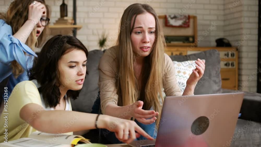 young female student becomes nervous and upset, because computer laptop ...