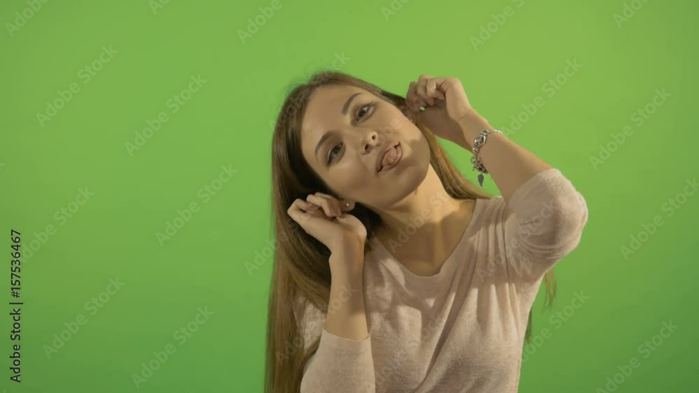 Beautiful white model is playing on the green screen background. He ...