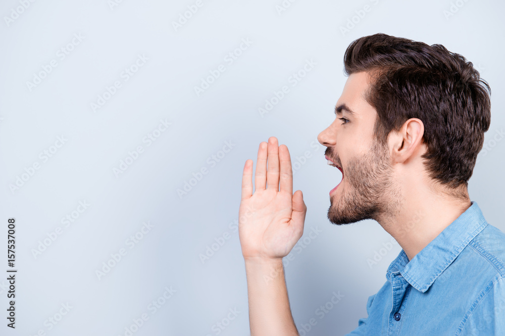 Side view of young man shouting isolated on light blue background ...