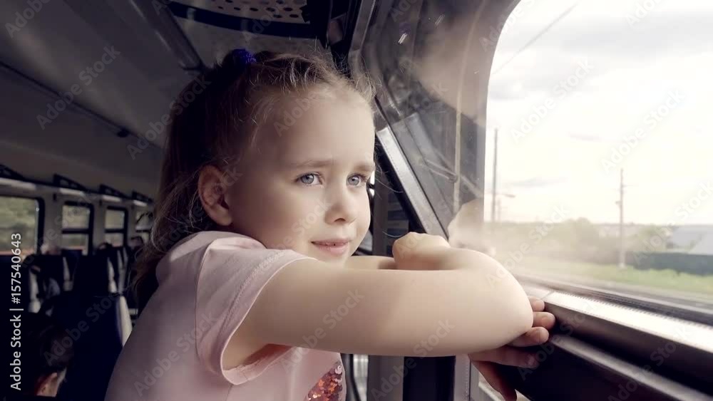 Vidéo Stock Beautiful little girl with big blue eyes stares out of the ...
