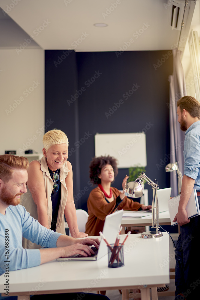 Caucasian businesswoman giving advice to her colleague while standing ...