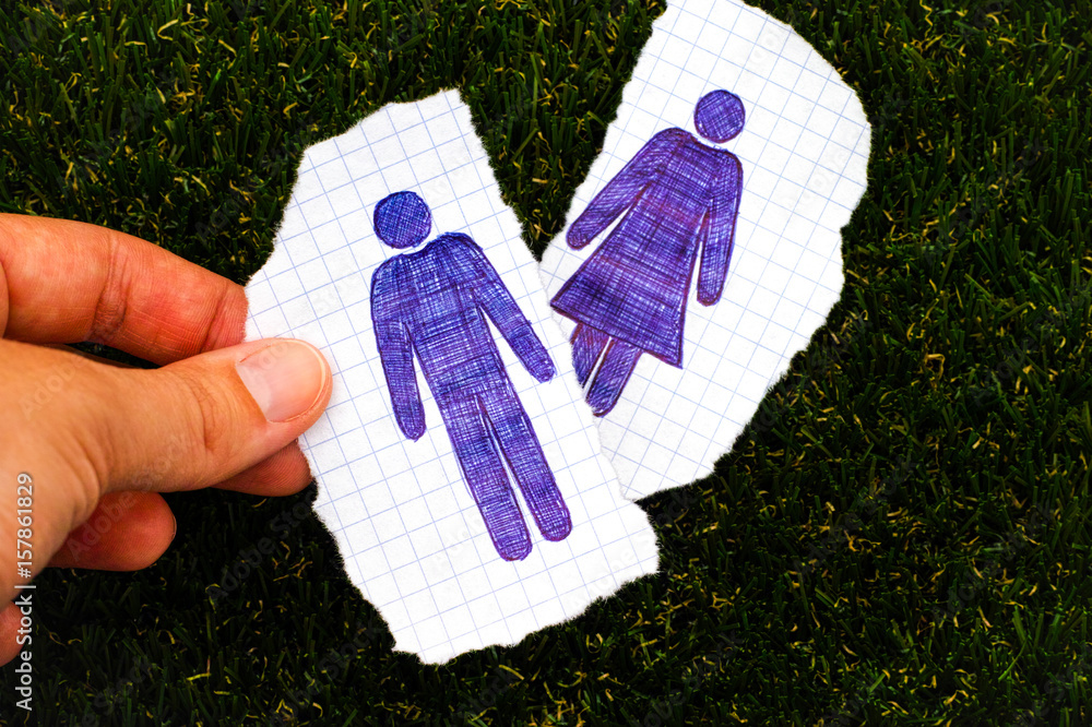 Person fingers holding piece of paper with hand drawn man figure. Other ...