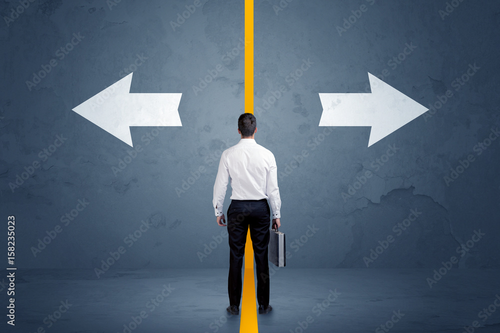 Business person choosing between two options separated by a yellow ...