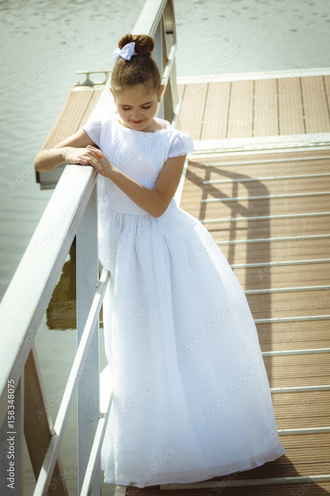 Niña rubia vestida de blanco en su primera comunión Stock Photo | Adobe ...