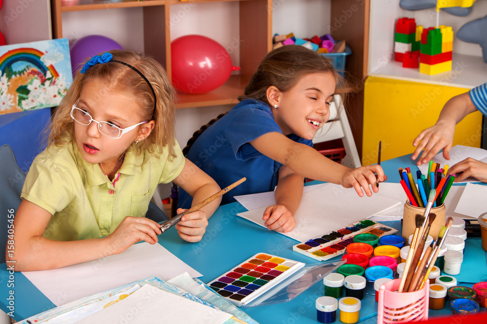Small students painting in art school class. Child drawing by paints on ...