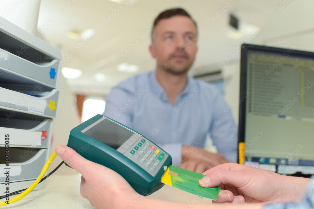 Medical woker putting health card into electronic reader Stock Photo ...