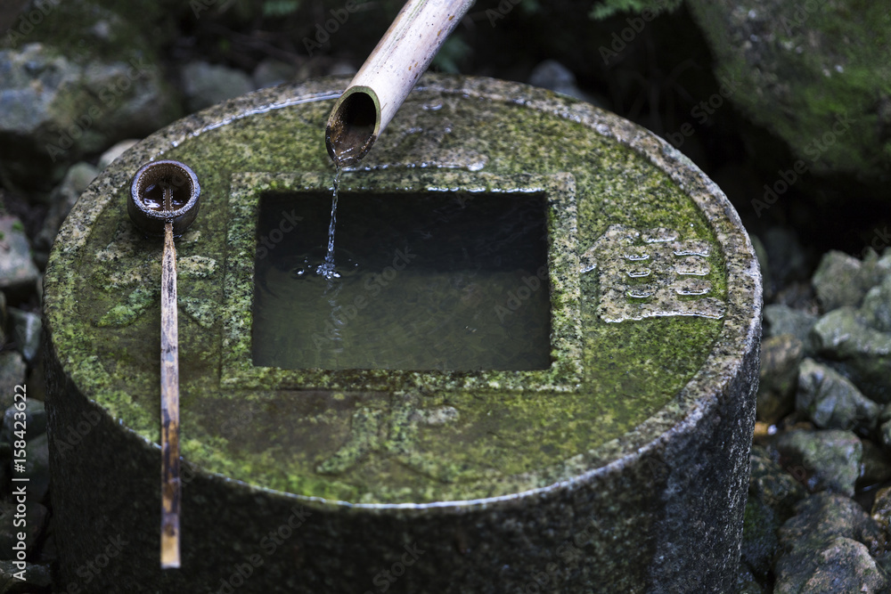 Japanese style traditional bamboo fountain and stone basin for hand ...