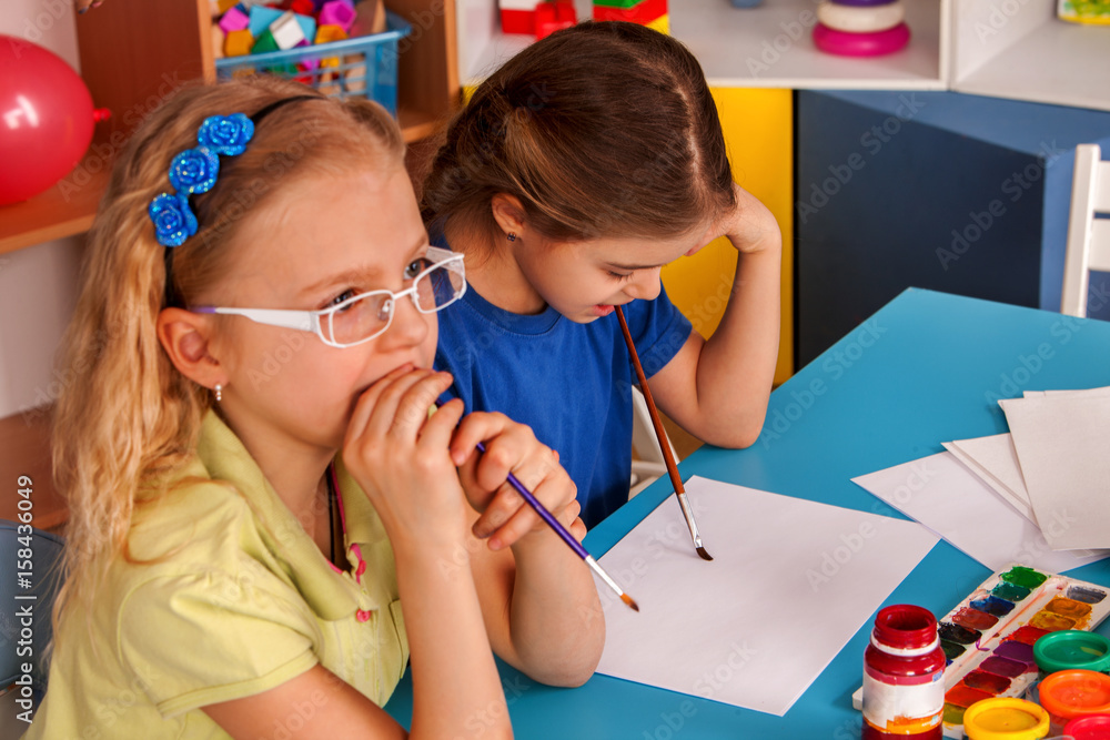 Small students painting in art school class. Child drawing by paints on ...