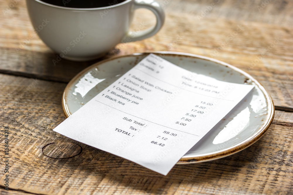 coffee and check on cafe wooden desk background Stock Photo | Adobe Stock