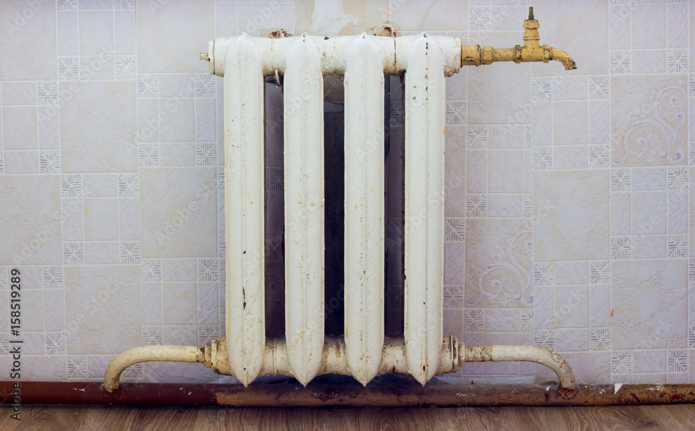 Old cast-iron radiator. In the old room a cast-iron battery of ...
