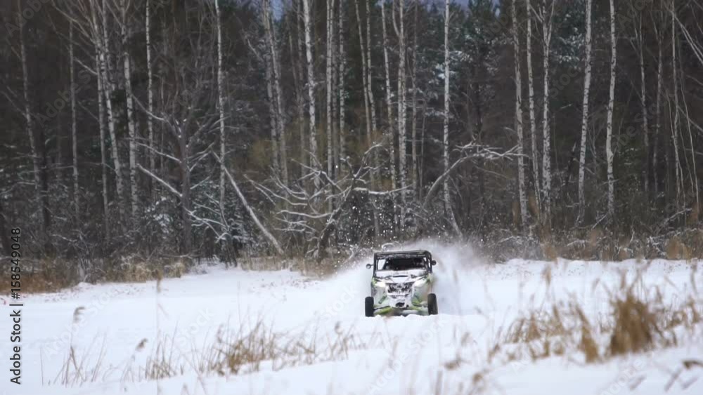 Winter racing side-by-side vehicles. Rally on the buggy on the snow on ...