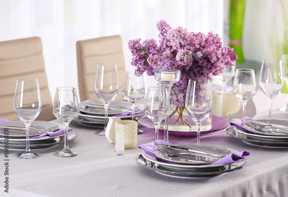 Beautiful table setting with silver cutlery and lilac bouquet Stock ...