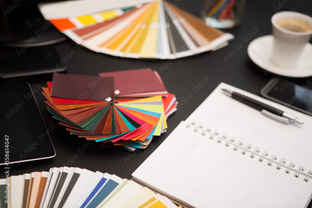 Workplace of designer with color palettes, gadgets and notepad. Stock ...