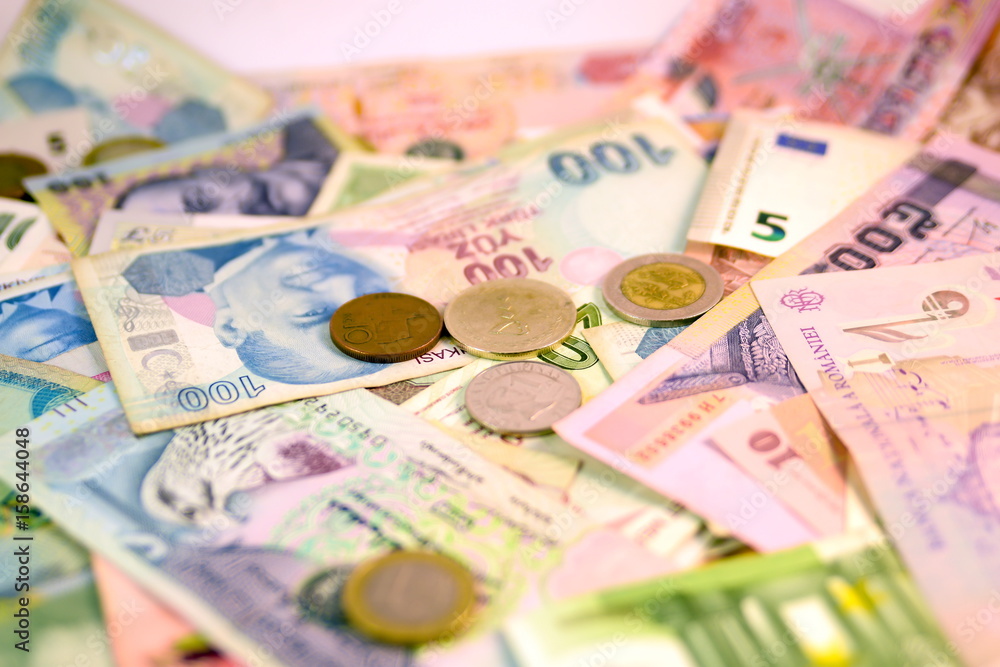 Different currency note and coins from different countries background ...