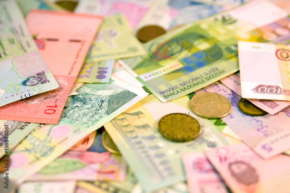 Different currency note and coins from different countries background ...