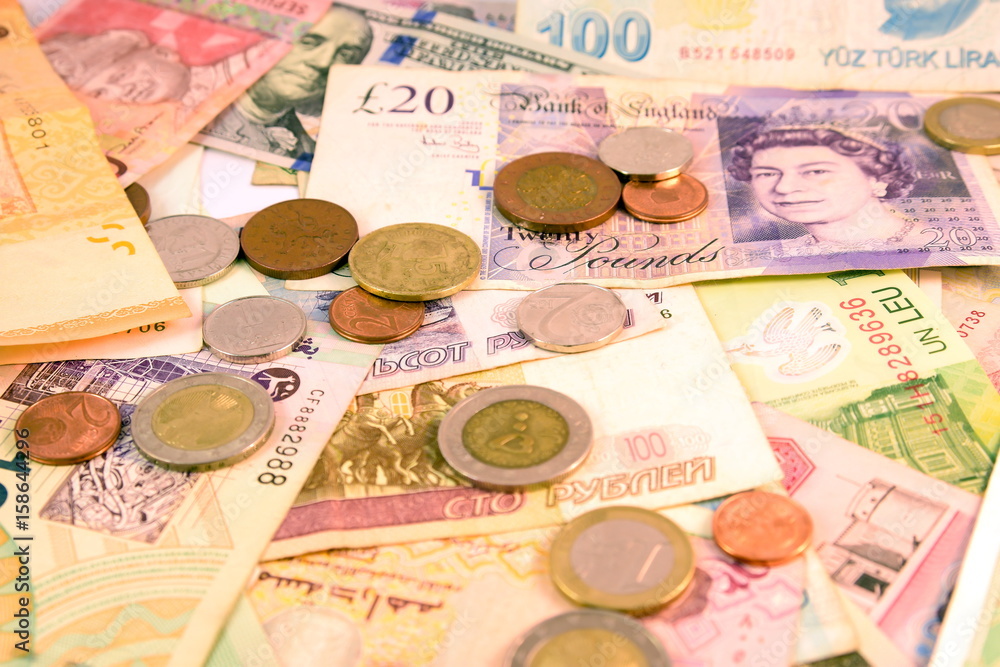 Different currency note and coins from different countries background ...