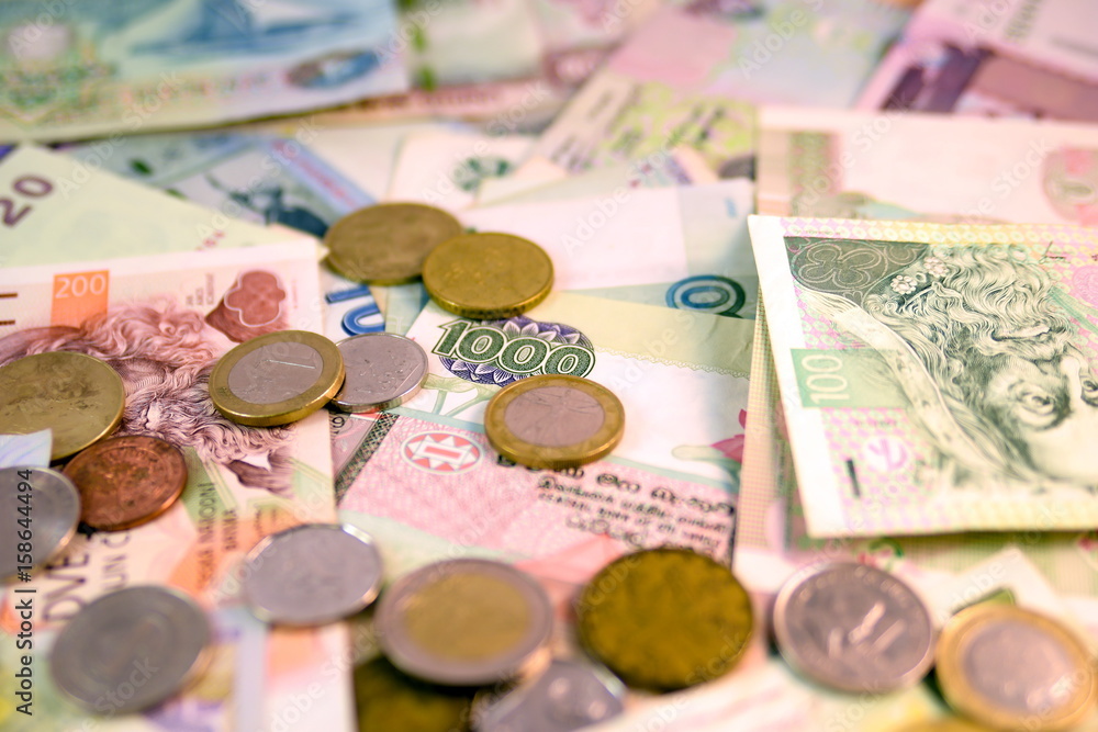 Different currency note and coins from different countries background ...