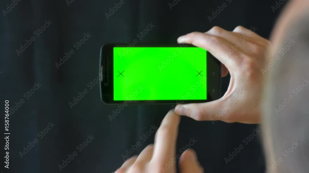 Close-up of male hands touching of smartphone. Green screen Chroma Key ...