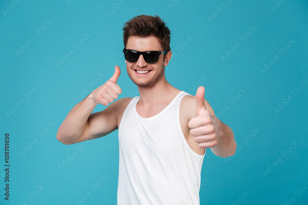 Man in sunglasses showing thumbs up gesture Stock Photo | Adobe Stock