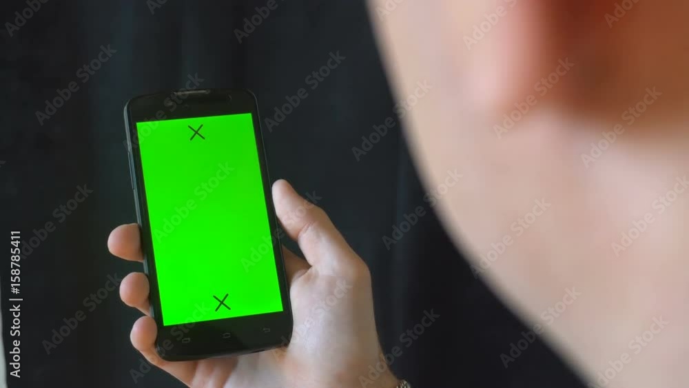 Close-up of male hands touching of smartphone. Green screen Chroma Key ...