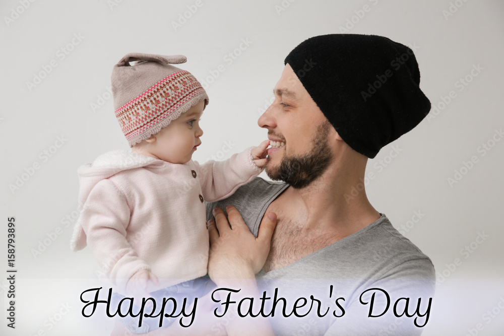 Father posing with cute baby daughter on light background Stock Photo ...