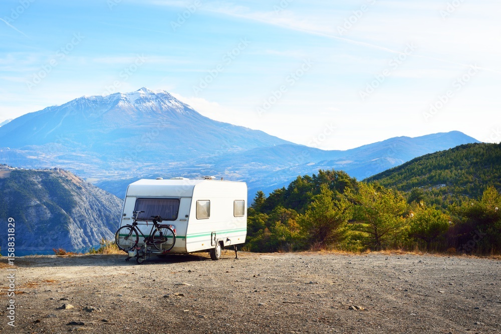 Caravan with a bike parked on a mountaintop with a view on the french ...