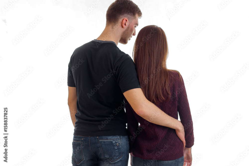 young romantic couple faces backwards and hugging Stock Photo | Adobe Stock