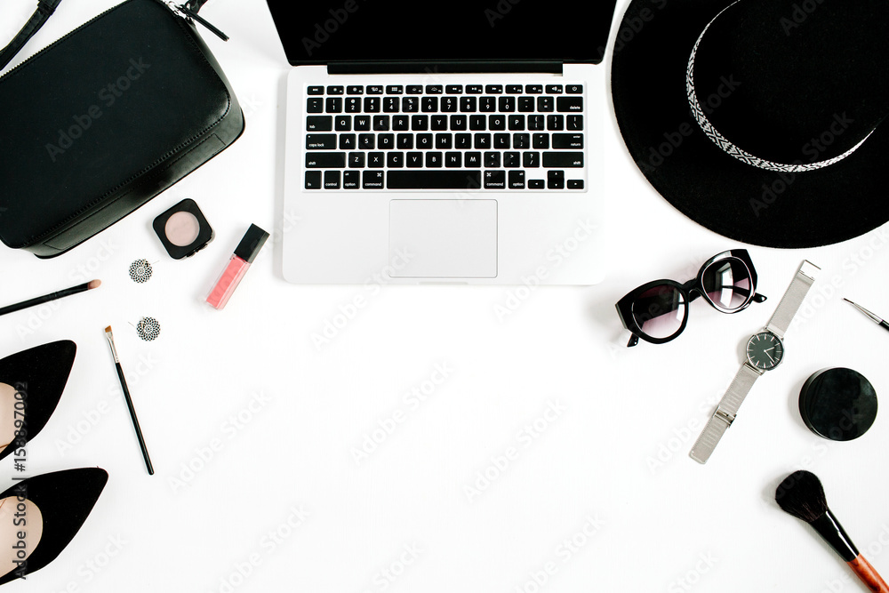 Fashion blogger office desk with laptop and black styled woman clothes ...