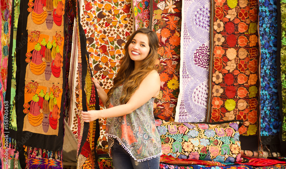 Beautiful smiling young woman touching andean traditional clothing ...