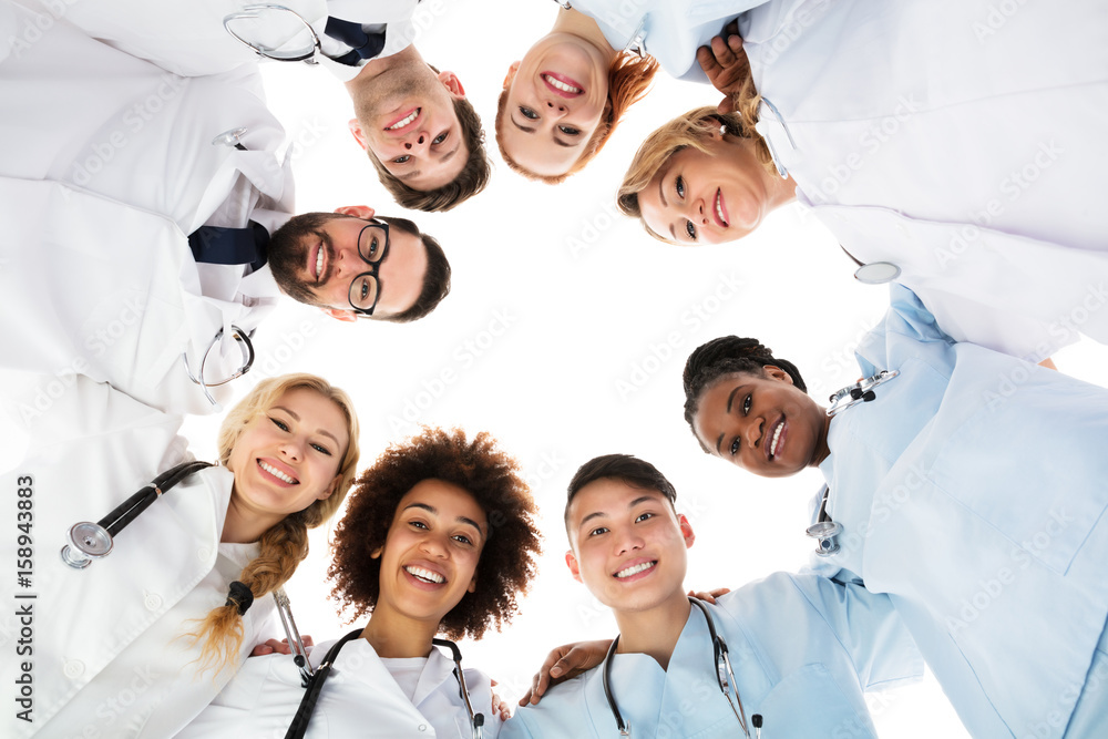 Happy Medical Team Forming Huddle Stock Photo | Adobe Stock