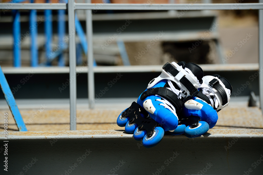 Roller inline skates in skate park on gray urban background Stock Photo ...