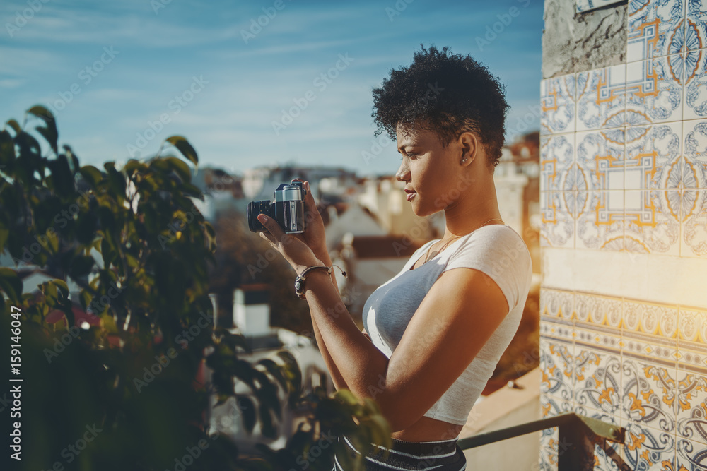 Charming young afro american lady shooting on her vintage film photo ...