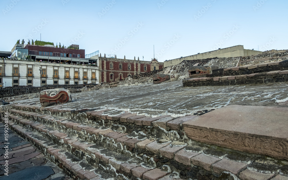 Aztec Temple (Templo Mayor) and serpent head at ruins of Tenochtitlan ...