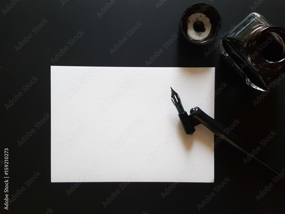 Sheet of paper, pen and ink of black on black office desk. Stock Photo ...