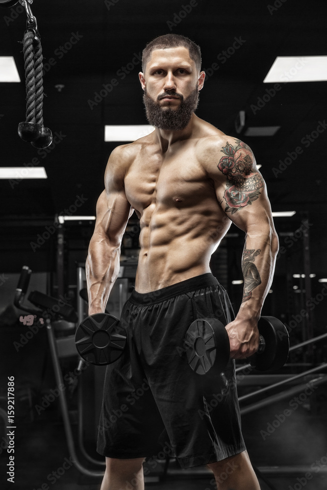 Attractive tall muscular bodybuilder doing heavy deadlifts in moder ...