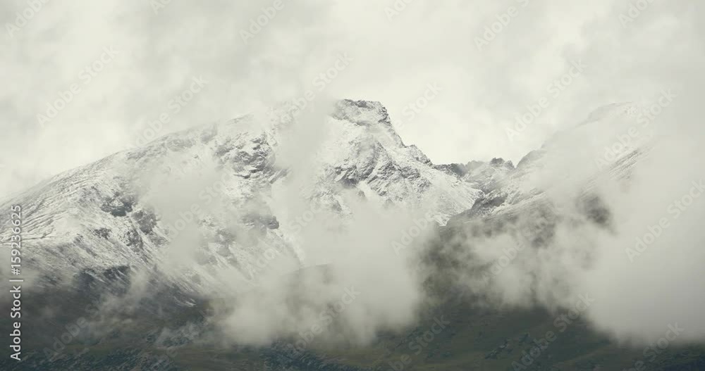 4k dark clouds mass rolling over Tibet snow-Covered mountains,Danggula ...
