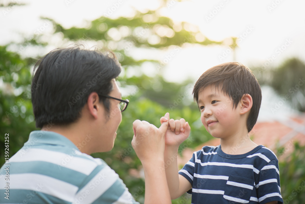 Asian father and his son making a pinkie promise Stock Photo | Adobe Stock
