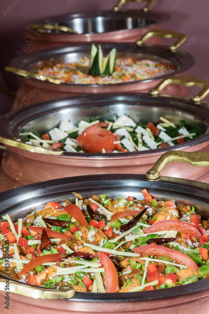 Indian lunch buffet or catering table with traditional brass copper ...
